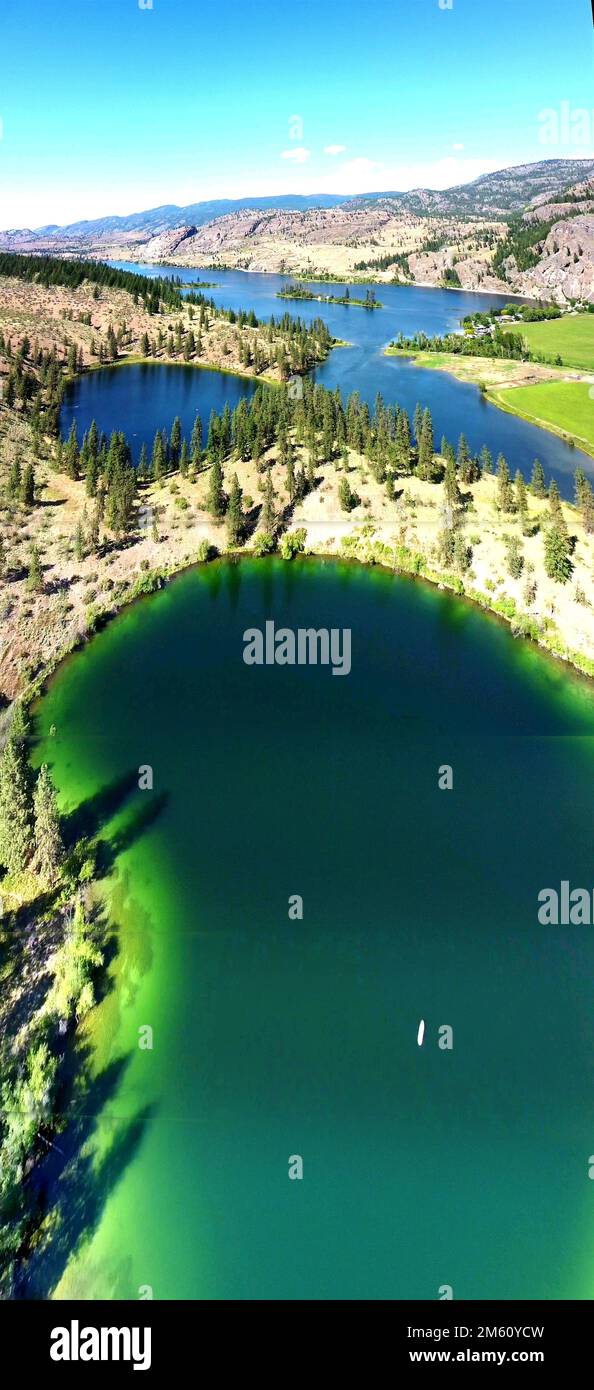 A vertical shot of a small ponds in a field in the daylight Stock Photo ...