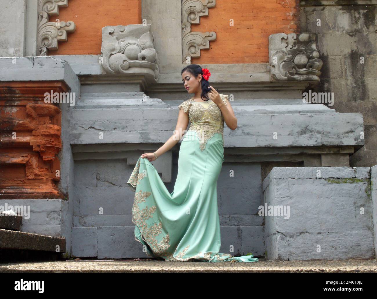 portrait of a Balinese woman wearing traditional Balinese fashion with ...