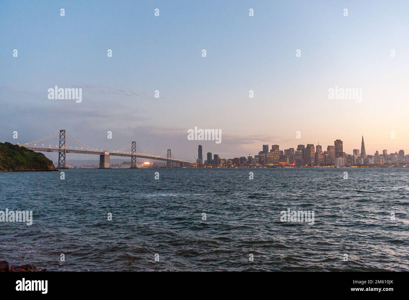 View of San Francisco - Oakland Bay Bridge and San Francisco skyline at dusk from Treasure ...
