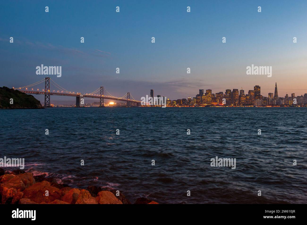 View of San Francisco - Oakland Bay Bridge and San Francisco skyline at dusk from Treasure ...
