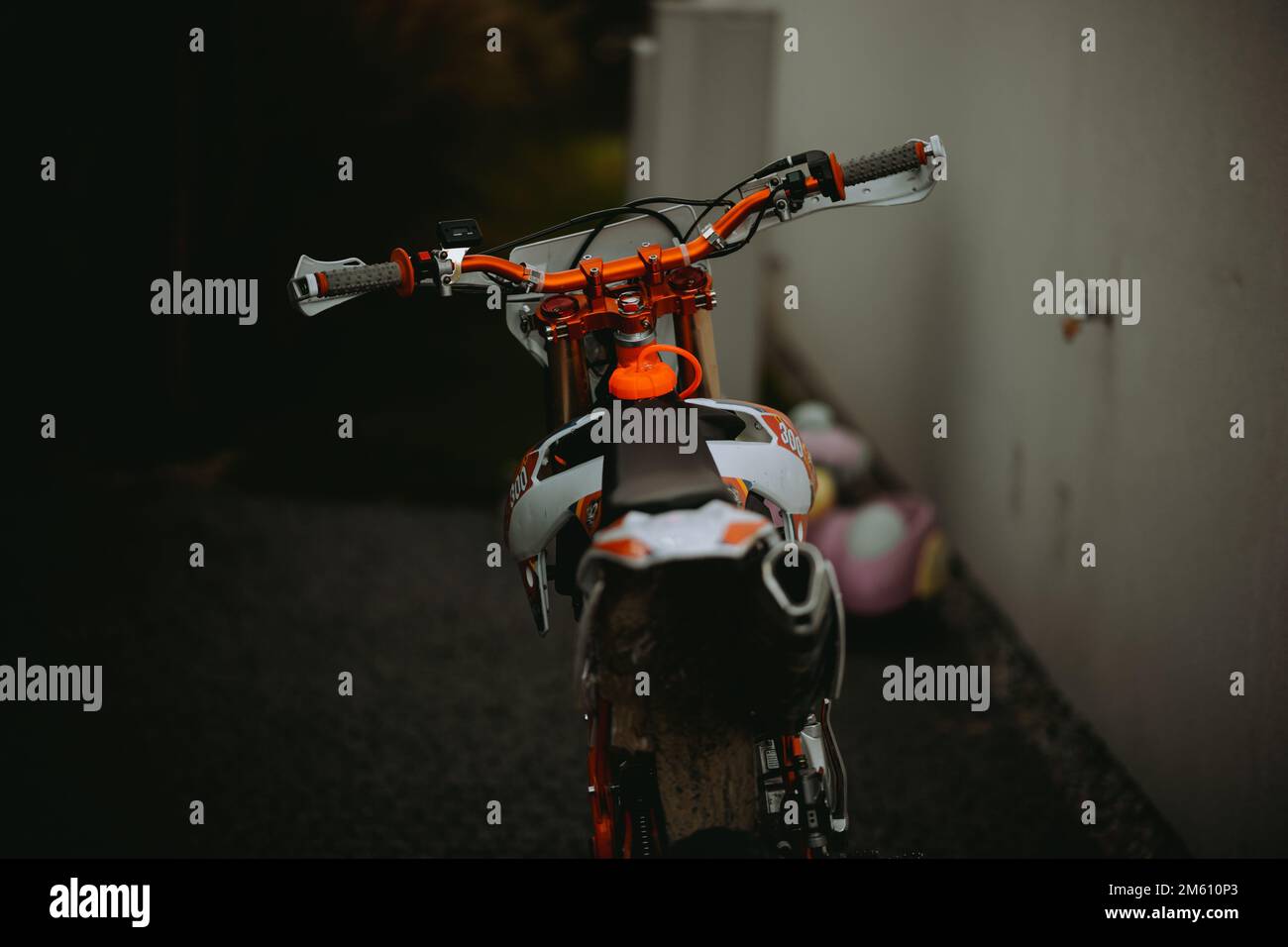 A closeup shot of a modern bike parked near the wall Stock Photo - Alamy