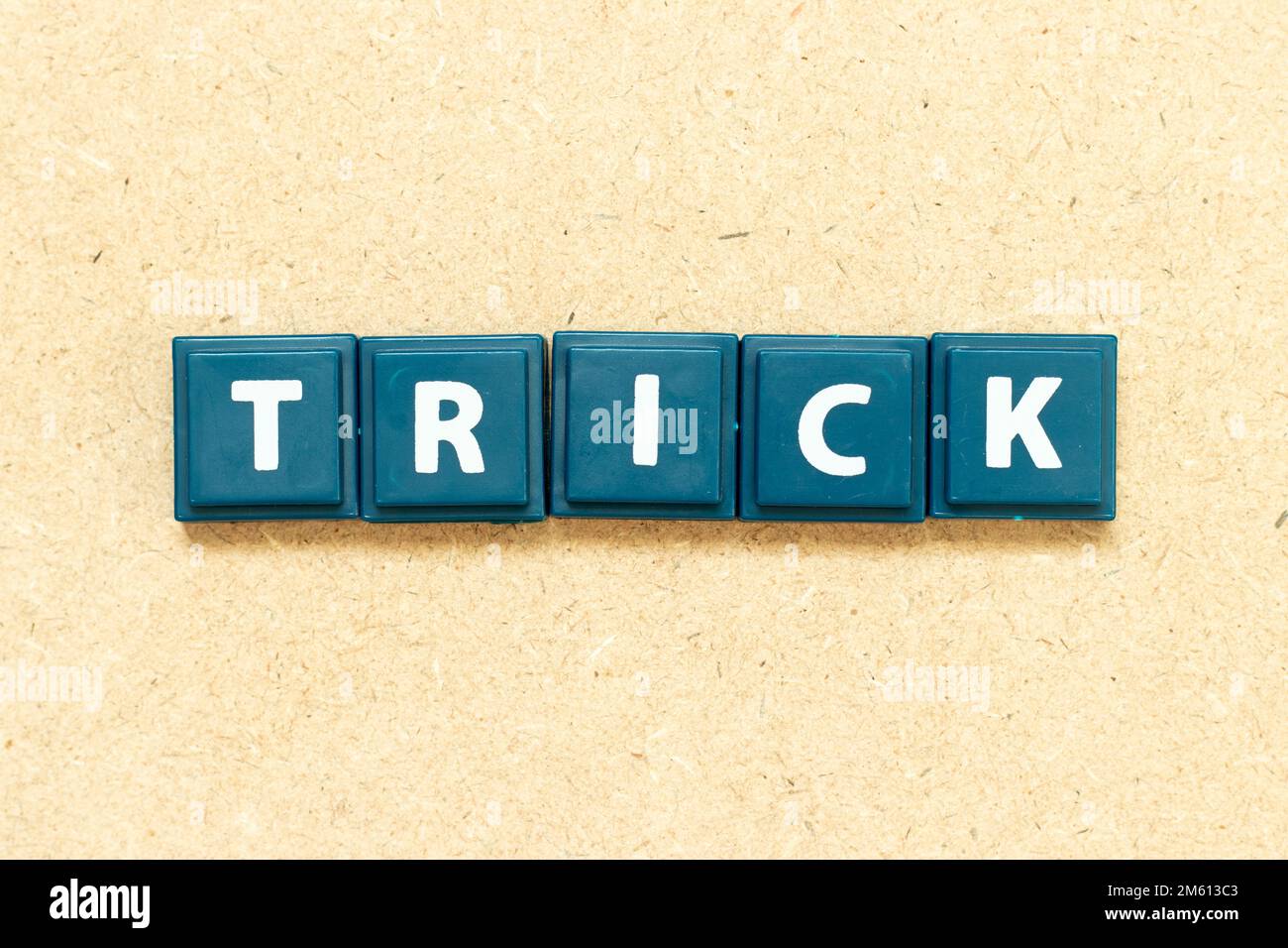 Tile alphabet letter in word trick on wood background Stock Photo - Alamy
