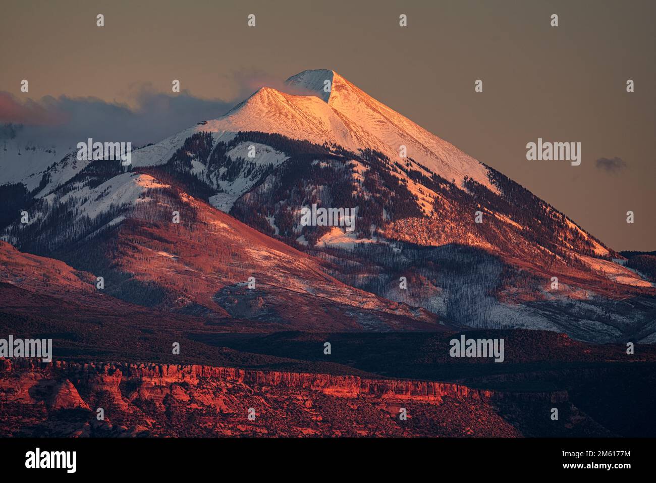 Snow capped La Sal Mountains and petrified dunes at sunset in Arches ...