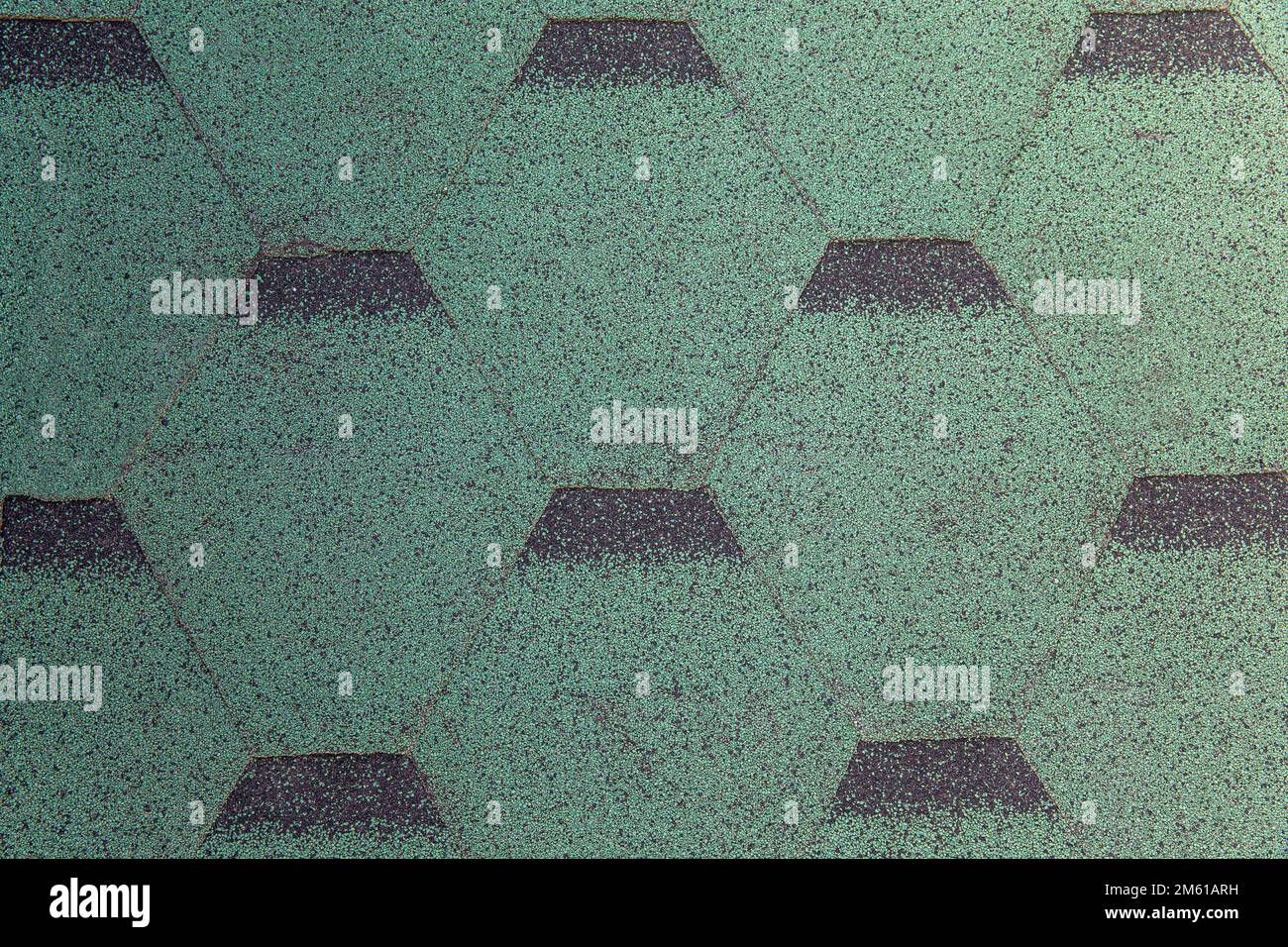 Roofing made of green soft bitumen tiles on a hipped roof of a house ...