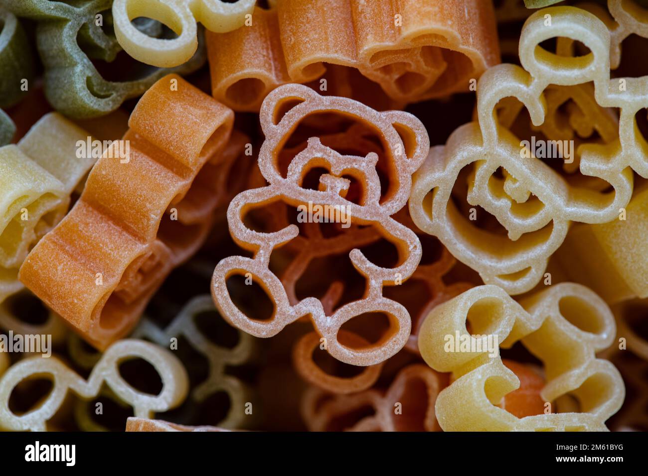 Closeup of Teddy Bear shapes colorful pasta background for design ...