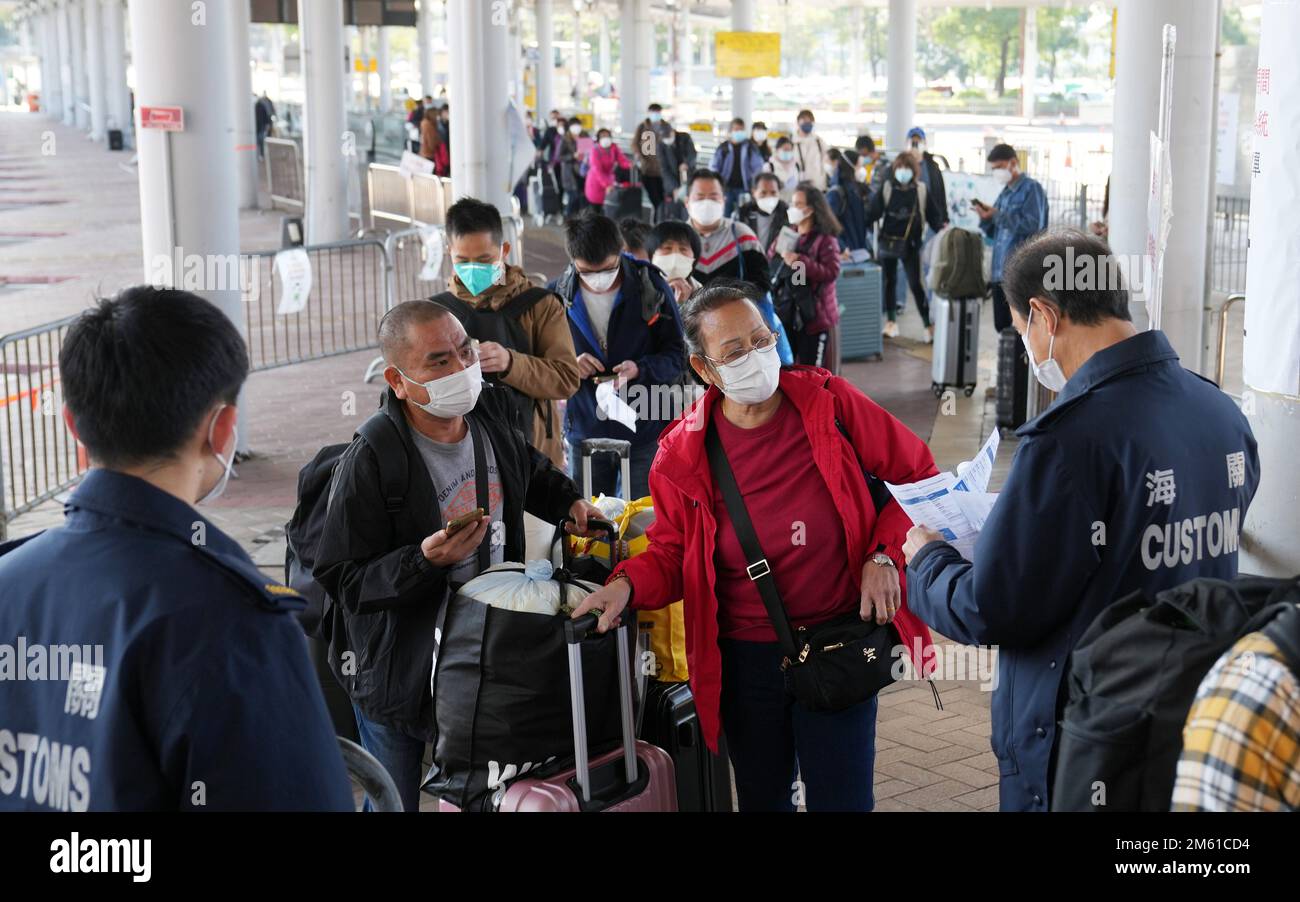 Travellers in Hong Kong wait to cross the border into mainland China ...
