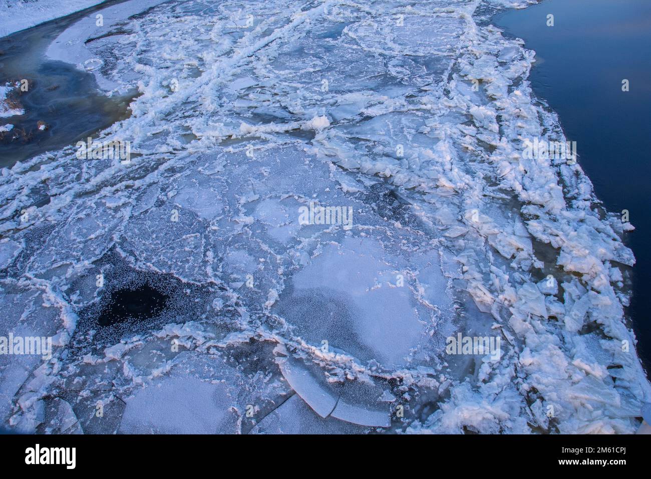 Ice-bound river and floating floe on a sunny frosty winter day Stock ...