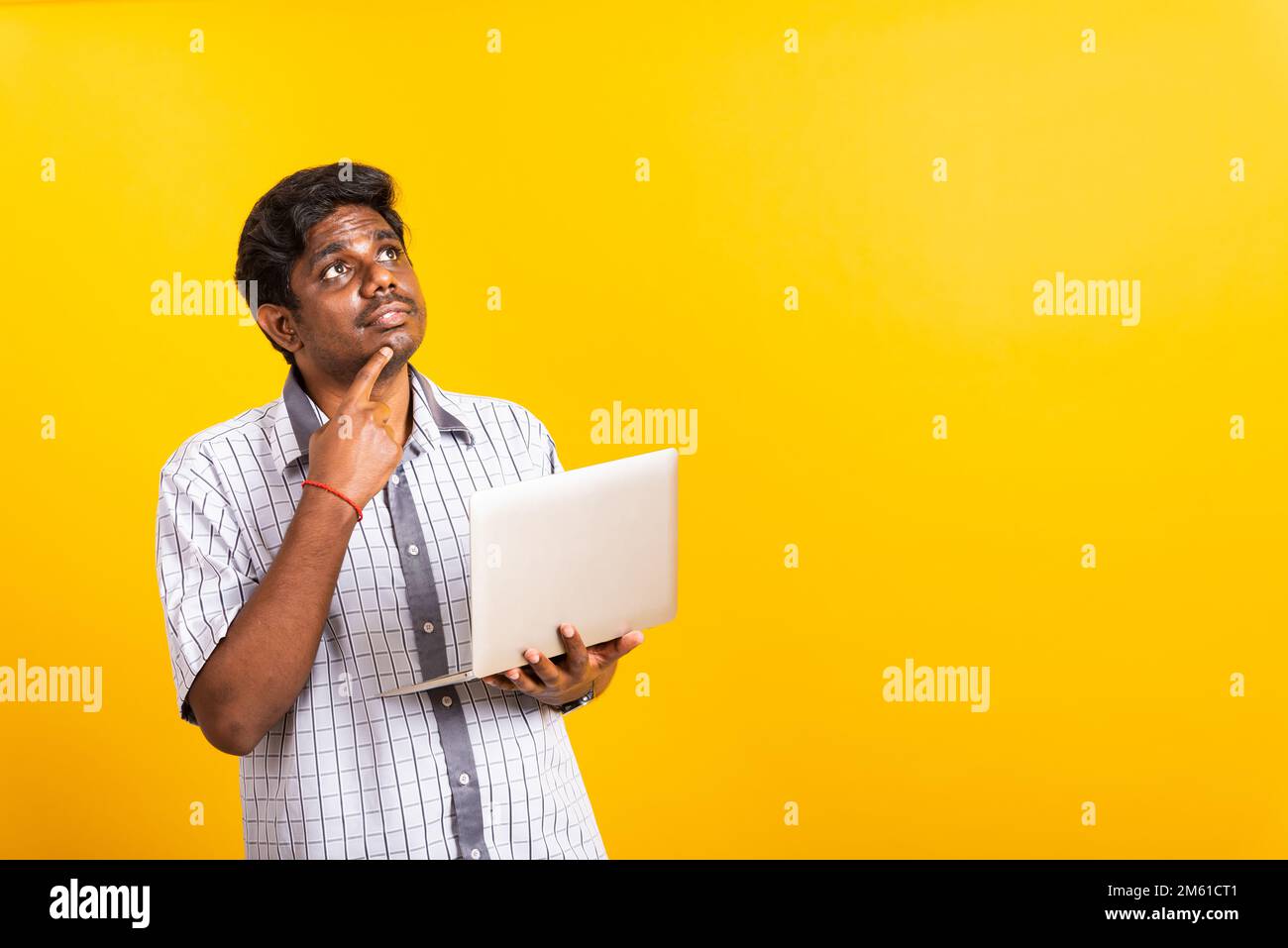 black man holds a laptop computer hand finger handle on the chin and ...