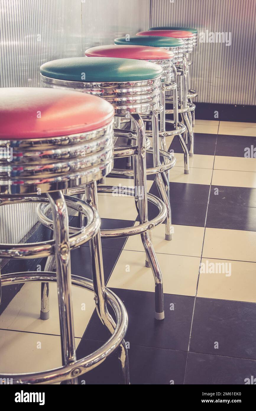 A vertical shot of colored stools at a classic American 1950s style ...