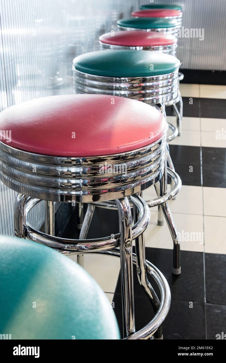 A vertical shot of colored stools at a classic American 1950s style ...