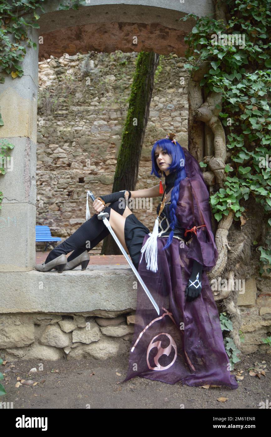 Young girls wearing a black bride like costume, warrior girl wielding a ...