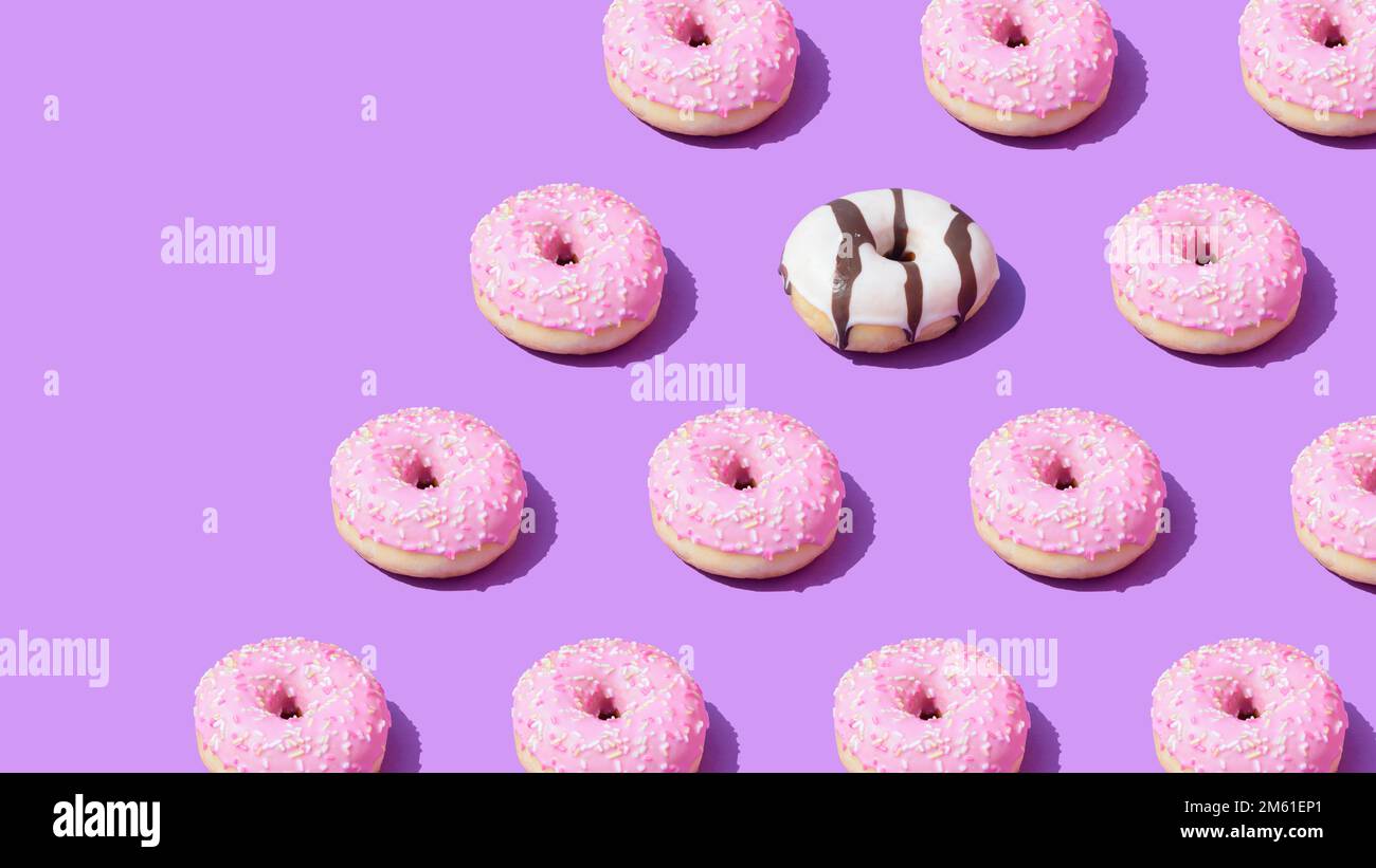 Pink and white doughnuts pattern on a purple background with diagonal ...