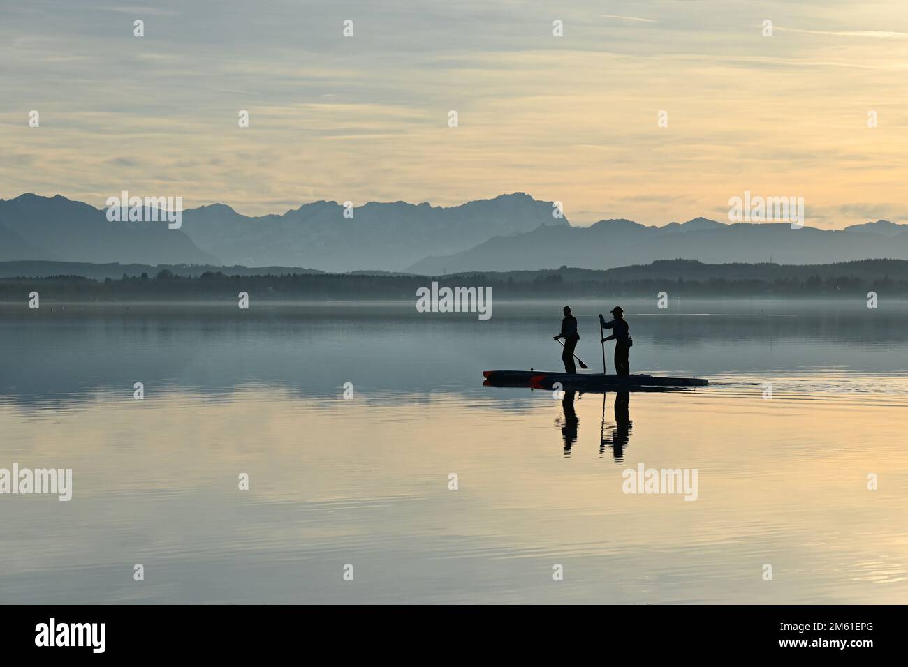Ambach, Germany. 01st Jan, 2023. Two stand-up paddlers are sailing ...