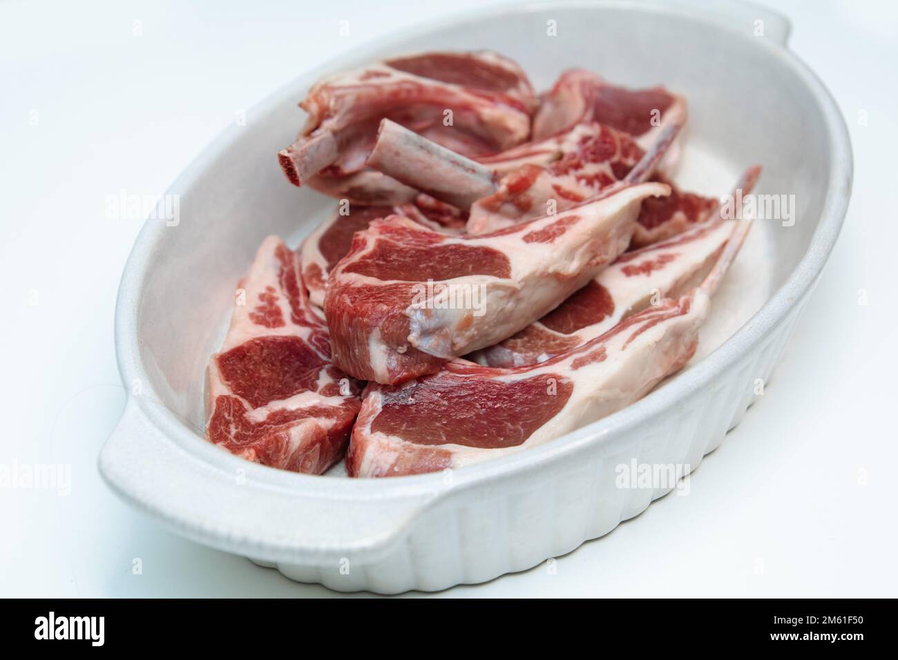Raw lamb cutlet on white background Stock Photo - Alamy