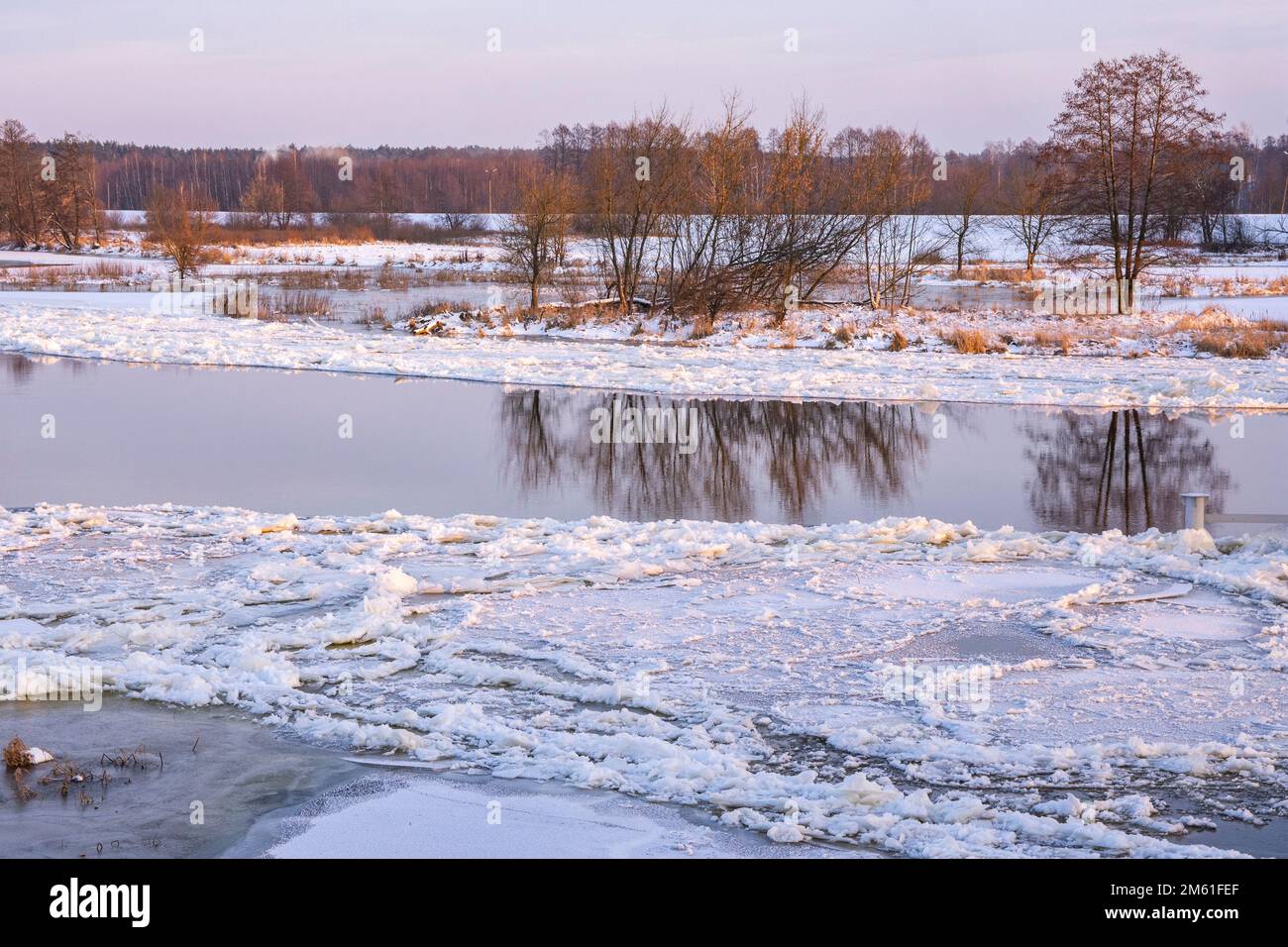 Ice-bound river and floating floe on a sunny frosty winter day. The ...