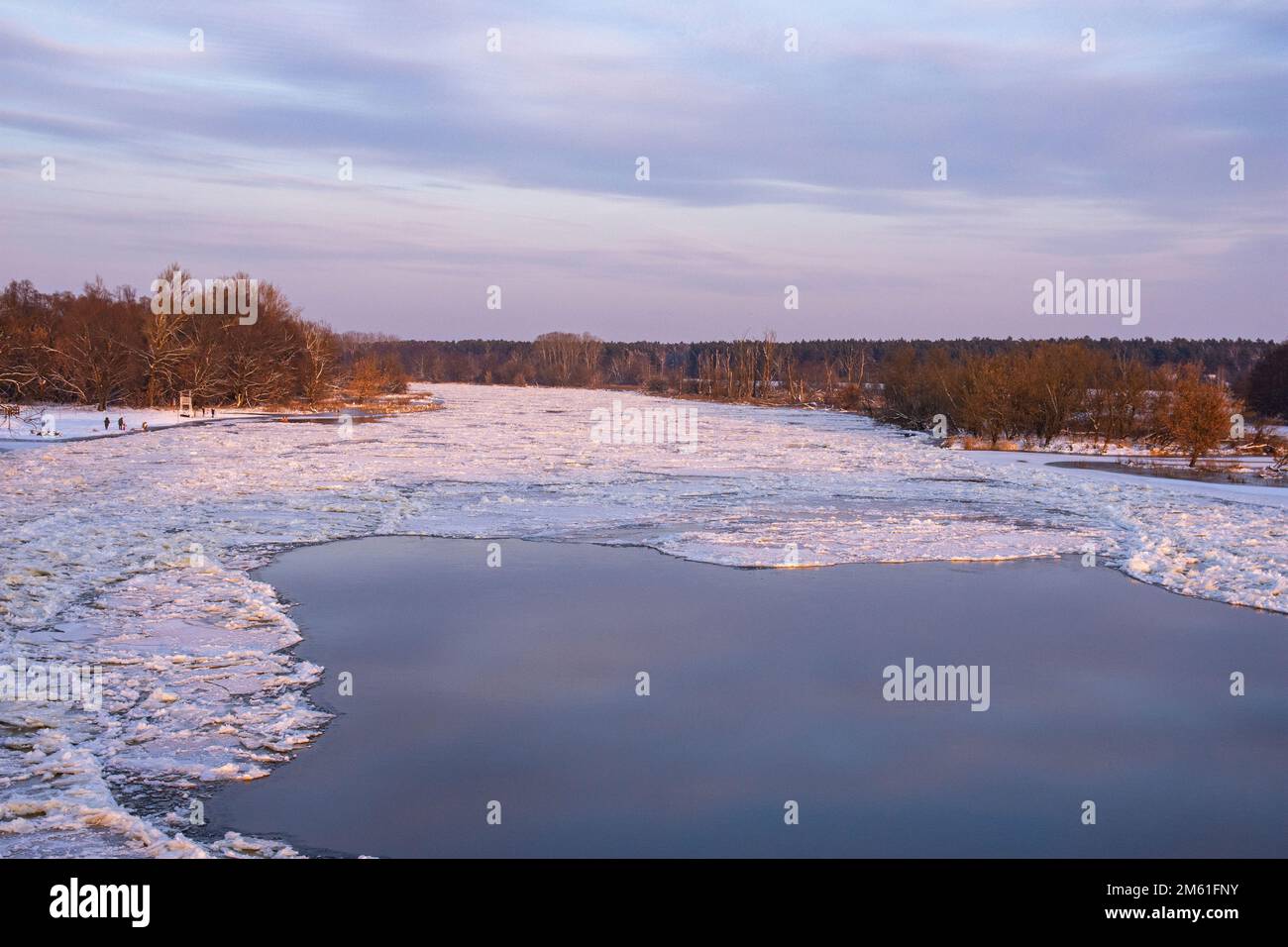 Ice-bound river and floating floe on a sunny frosty winter day. The ...