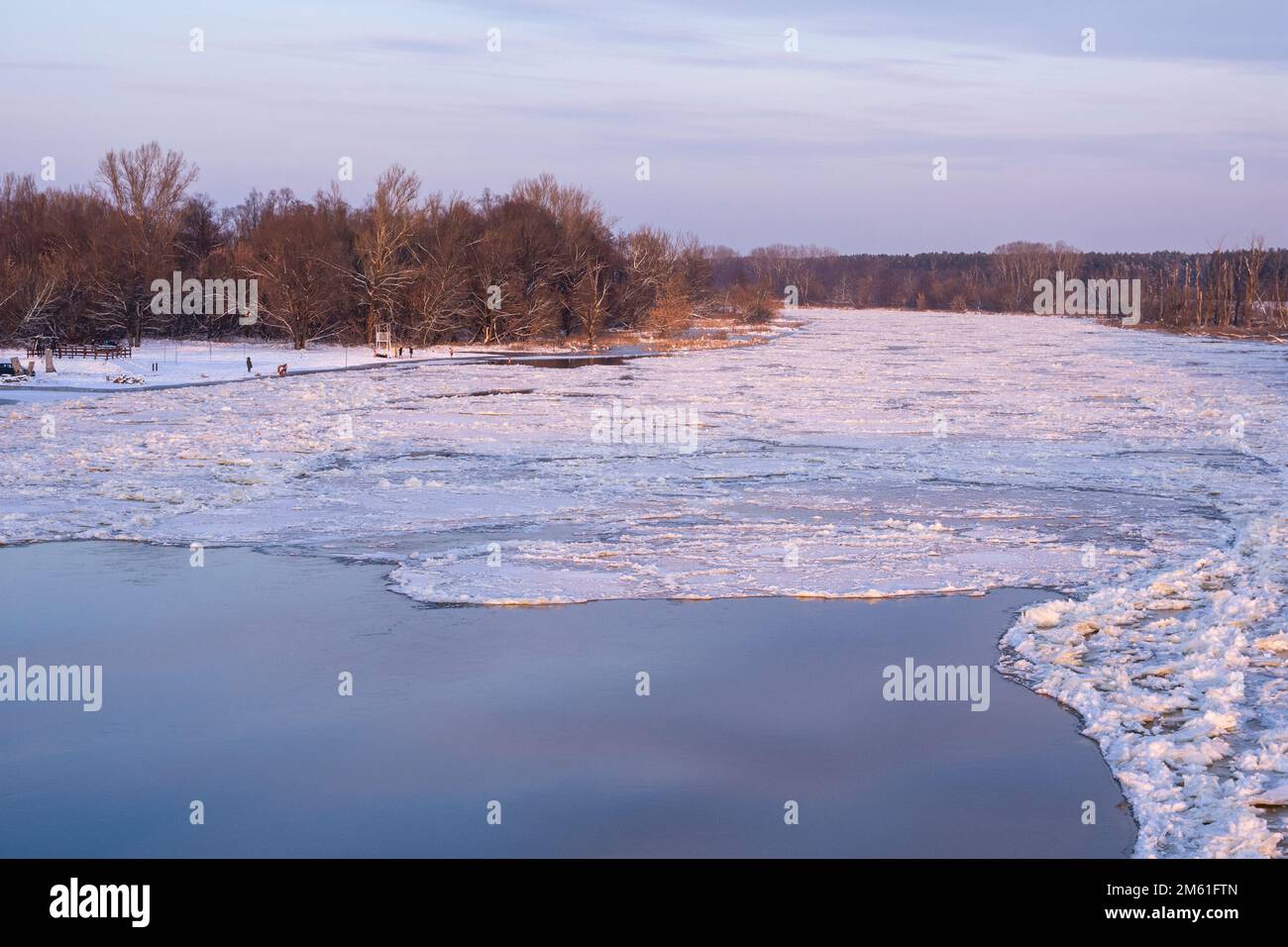 Ice-bound river and floating floe on a sunny frosty winter day. The ...