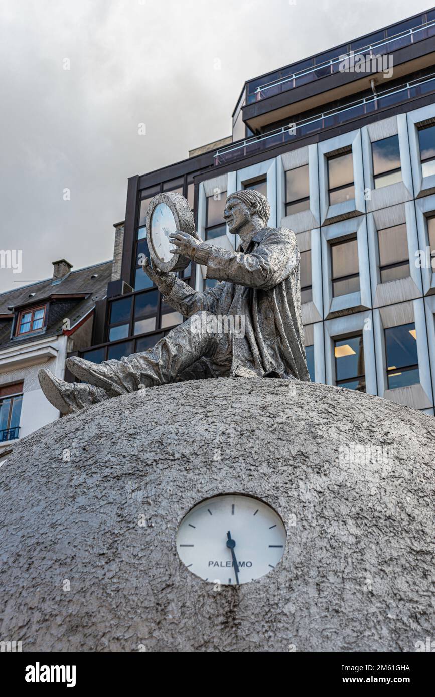 Statue of Man holding clock on top of a ball in Dijon, France Stock ...
