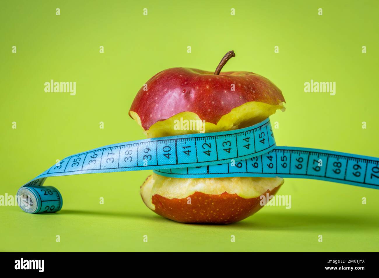 Weight loss concept, Bitten apple related by tailor meter, positive ...