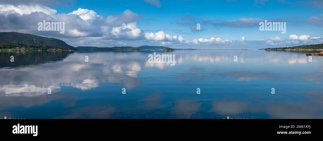 A panoramic view of the clear fjord under a blue sky in Jorpeland ...
