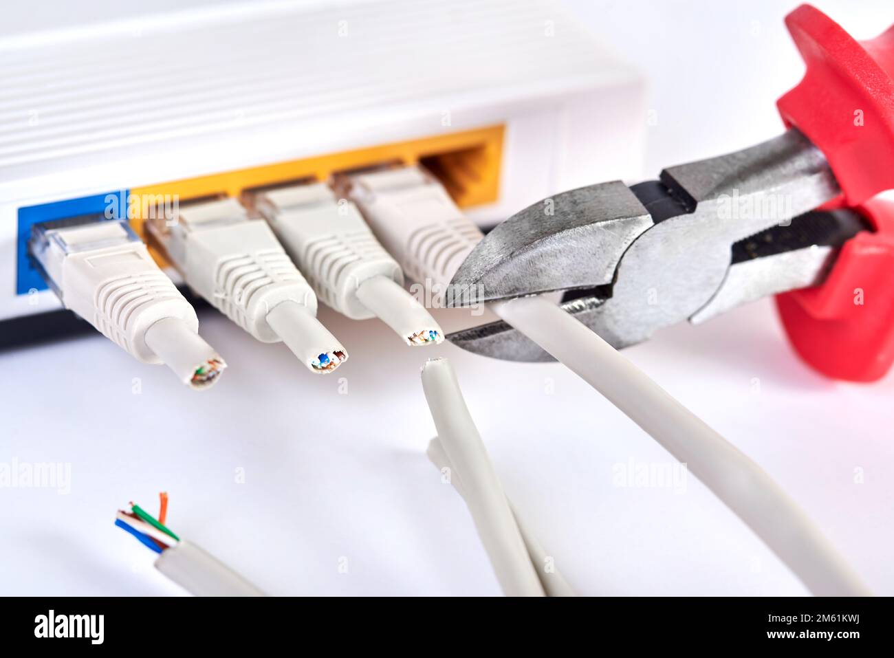 Wire cutters cuts the Internet cable into the router Stock Photo - Alamy