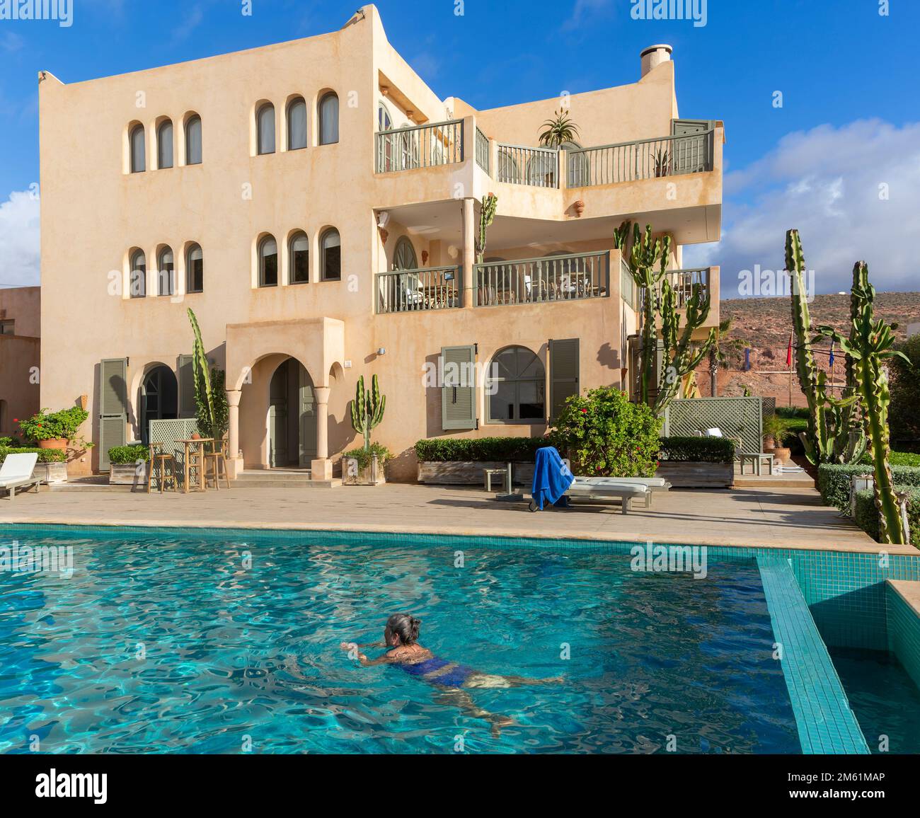 Woman swimming infinity pool by Hotel auberge Dar Najmat, Mirleft ...