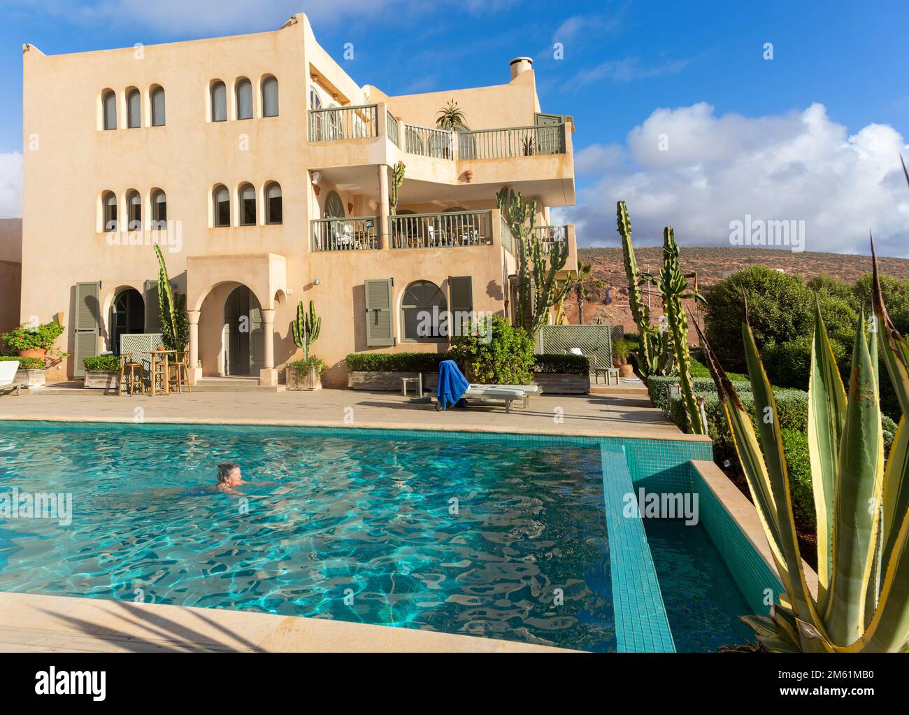 Woman swimming infinity pool by Hotel auberge Dar Najmat, Mirleft ...