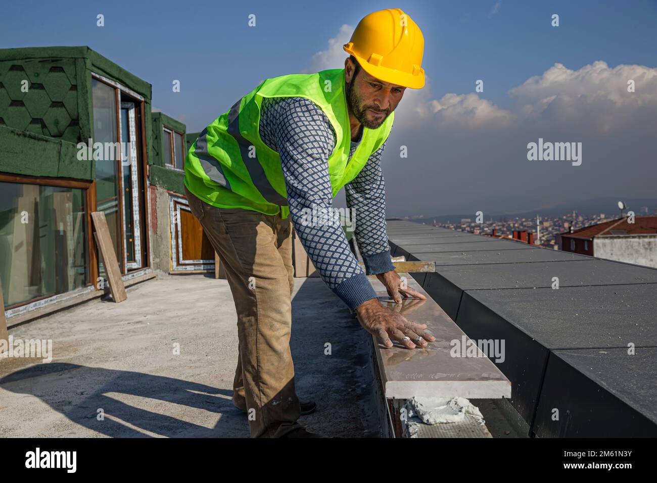 The builder is hitting the marble with a hammer and leveling it with a ...