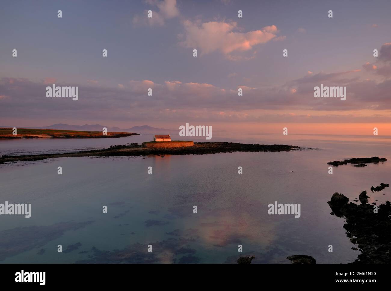 St Cwyfan’s Church on the island of Cribinau backed by the Lleyn ...