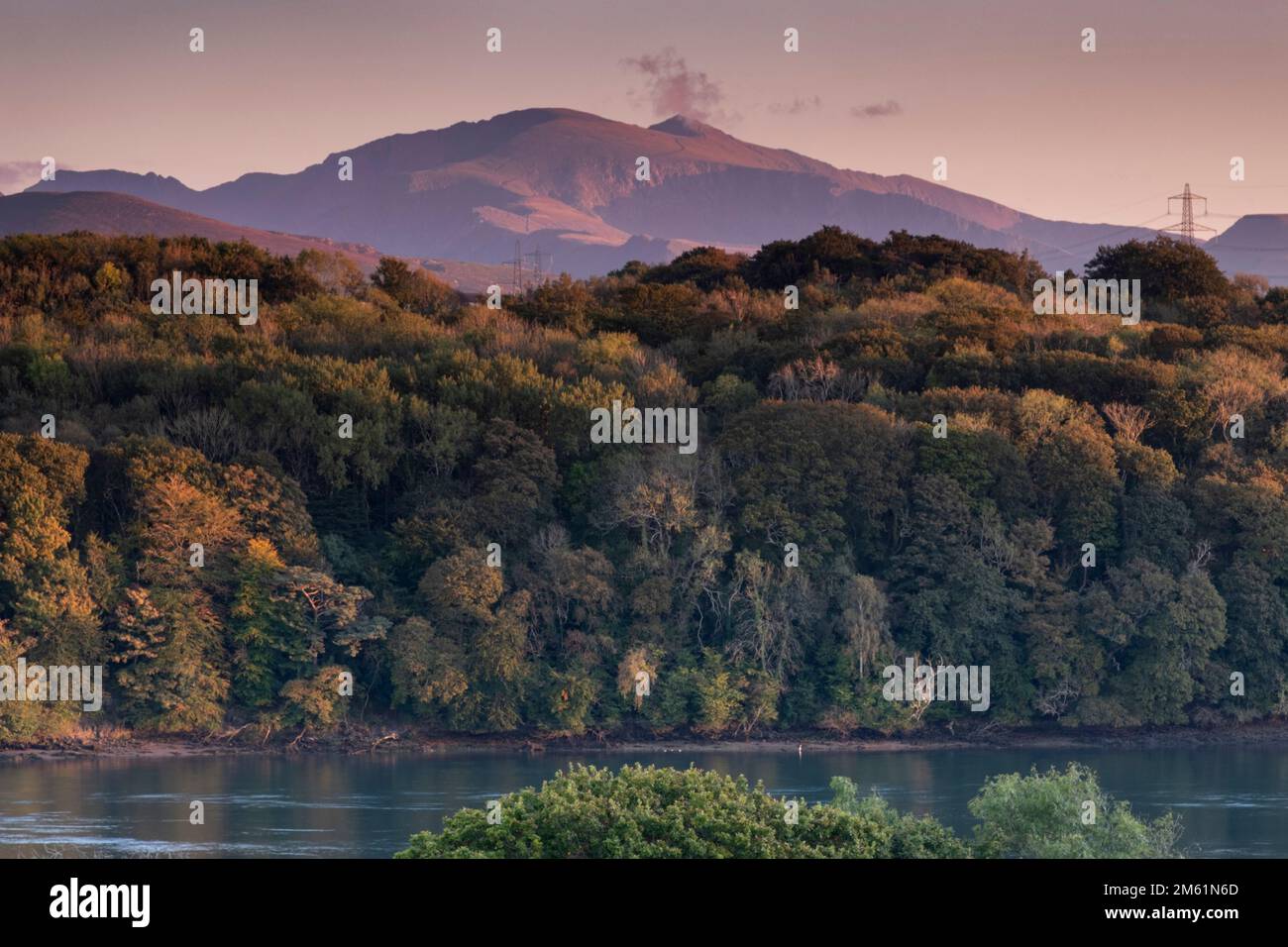 Mount Snowdon viewed over the Menai Strait in autumn, from Anglesey ...