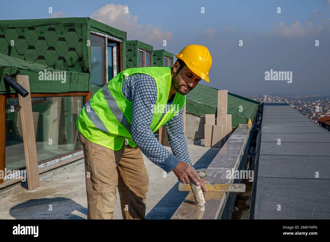 The builder is hitting the marble with a hammer and leveling it with a ...