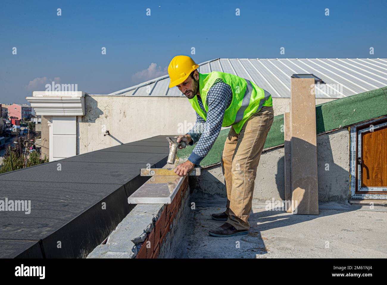 The builder is hitting the marble with a hammer and leveling it with a ...