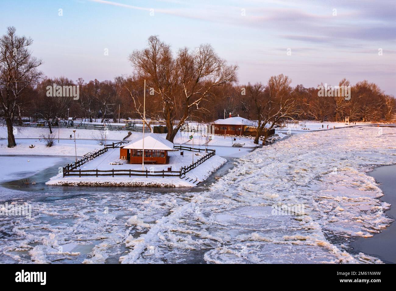 Frozen harbor and river covered with ice and floes in winter sunny ...