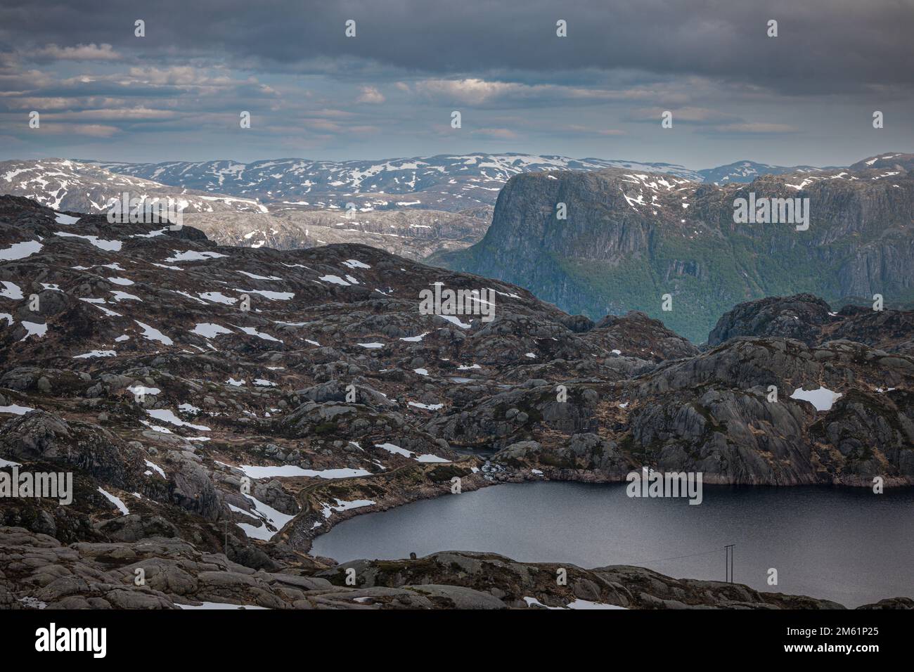 An aerial view of the rocky highlands with patches of snow in Lyseveien ...