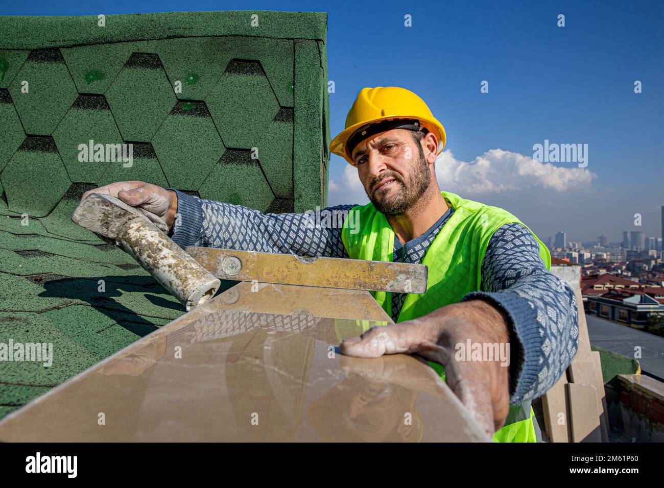The builder is hitting the marble with a hammer and leveling it with a ...