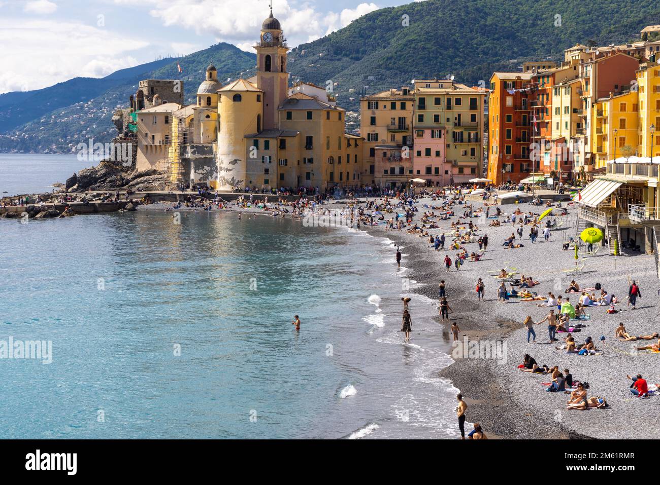 Panorama of the Camogli coast and beach with people. Little fishing ...