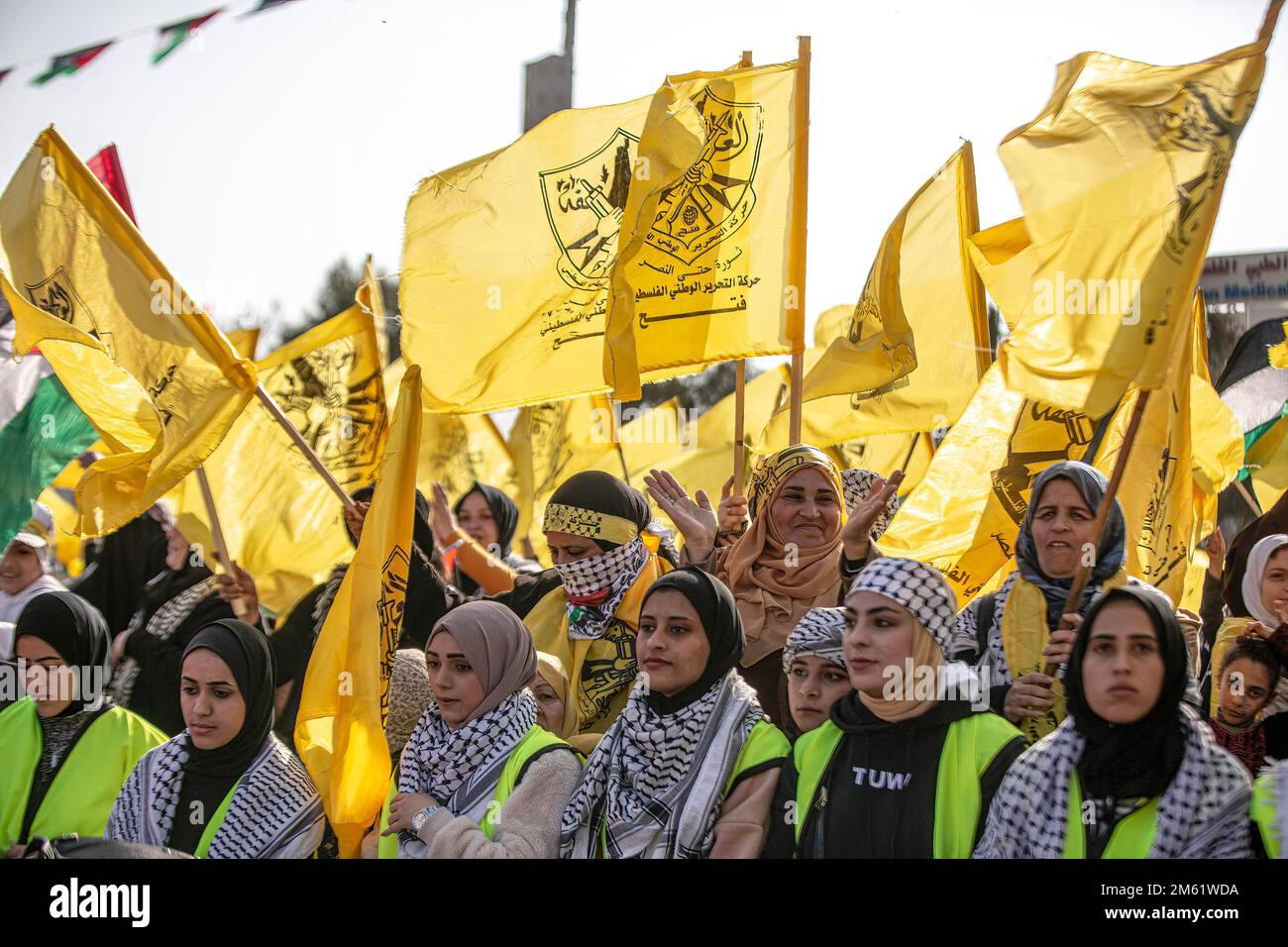 Palestinian supporters of the Fatah movement wave yellow flags while ...