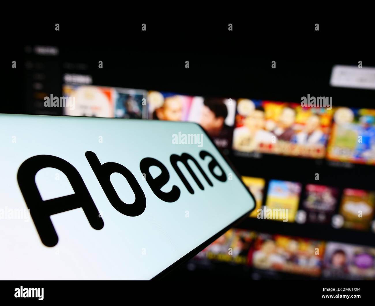 Mobile phone with logo of Japanese streaming company AbemaTV Inc. (Abema) on screen in front of ...