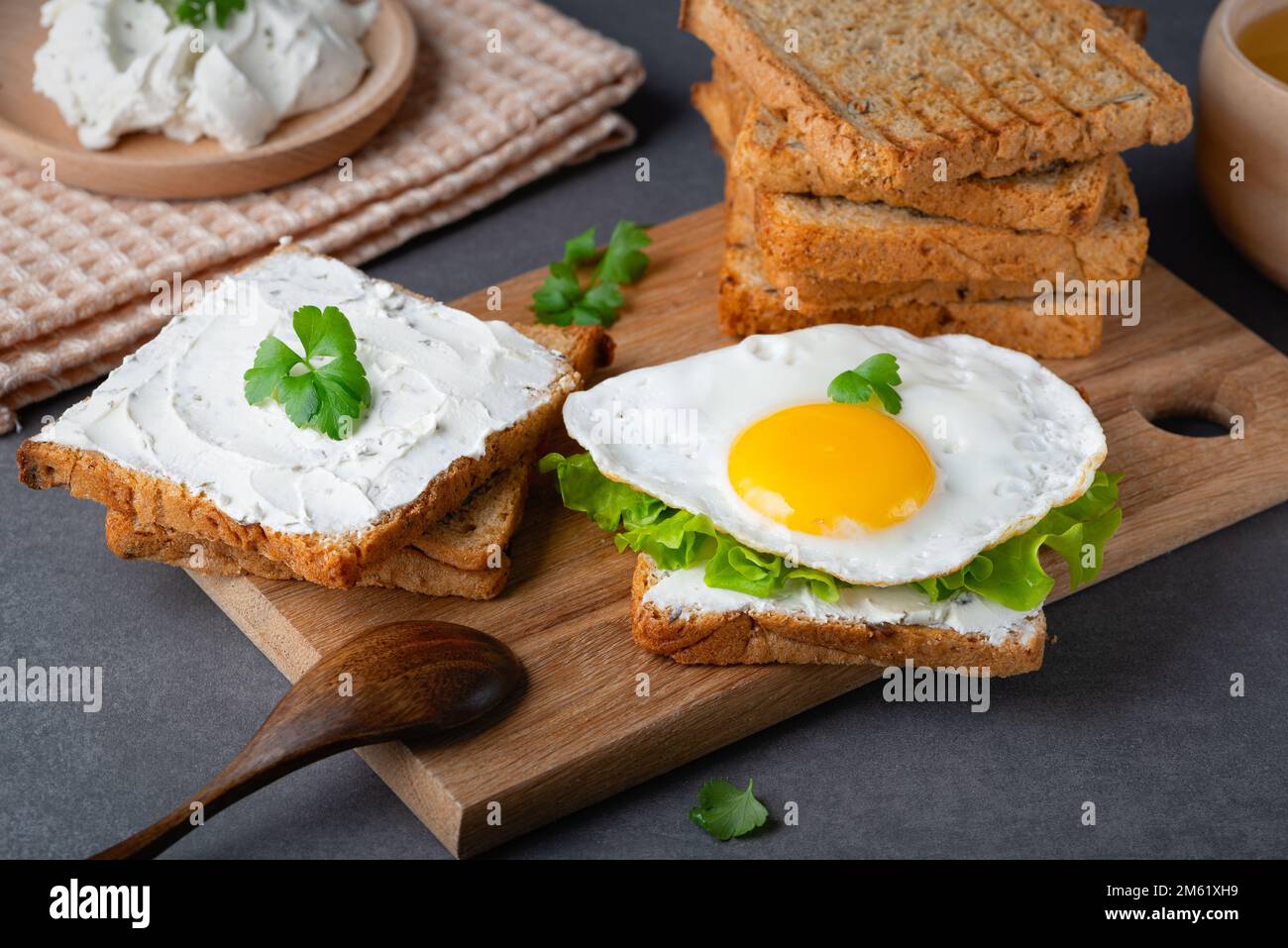 Sandwiches with curd cheese, fried egg and herbs Stock Photo - Alamy