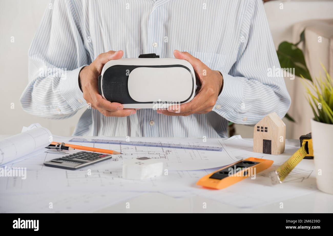 Architectural building design holding 3D VR glasses and construction ...