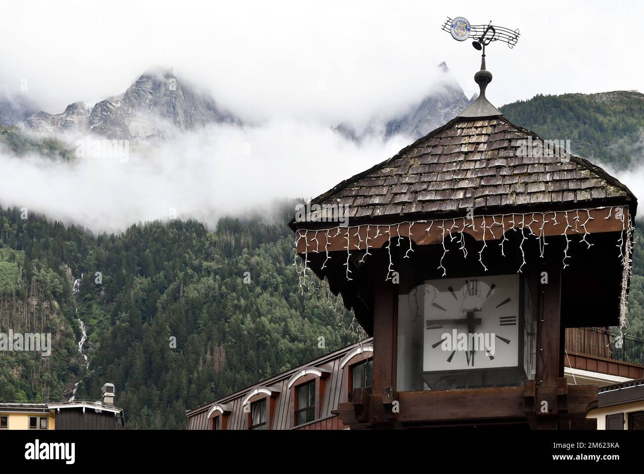 Wooden clock tower in the centre of Chamonix with the Aiguilles of ...