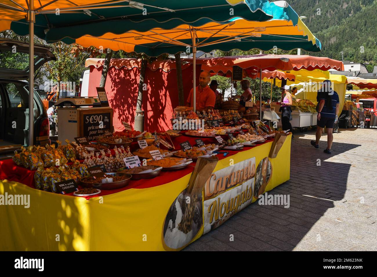 A stand of nougat and sweets at the street market of Chamonix in summer ...