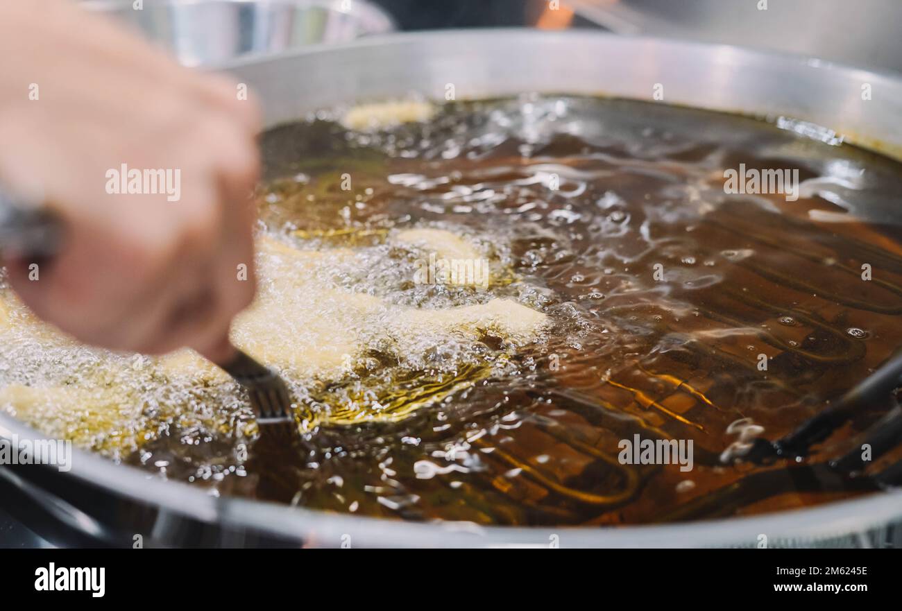 Preparation of fried churros with sugar typical of Spain Stock Photo ...