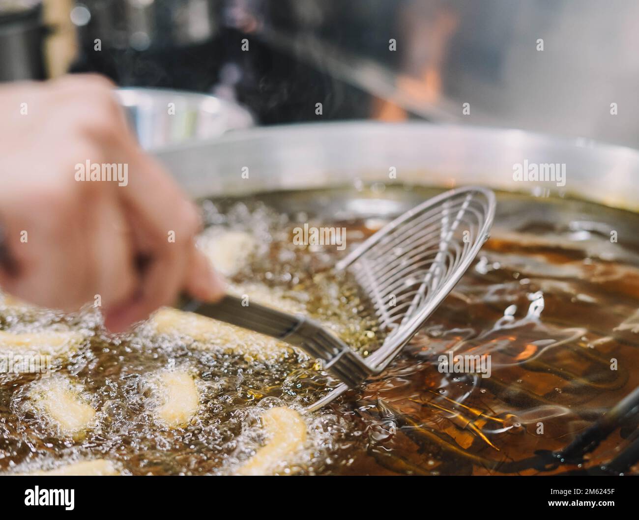 Preparation of fried churros with sugar typical of Spain Stock Photo ...