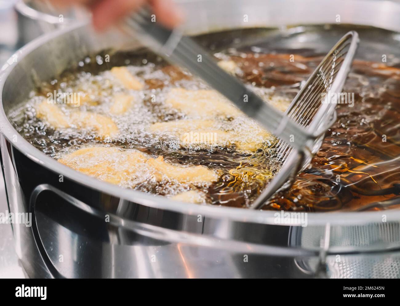 Preparation of fried churros with sugar typical of Spain Stock Photo ...