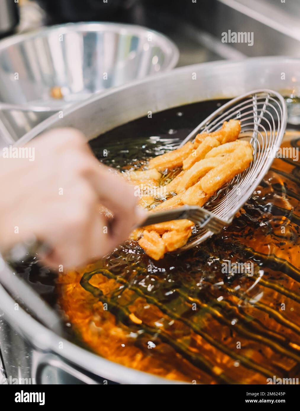 Preparation of fried churros with sugar typical of Spain Stock Photo ...