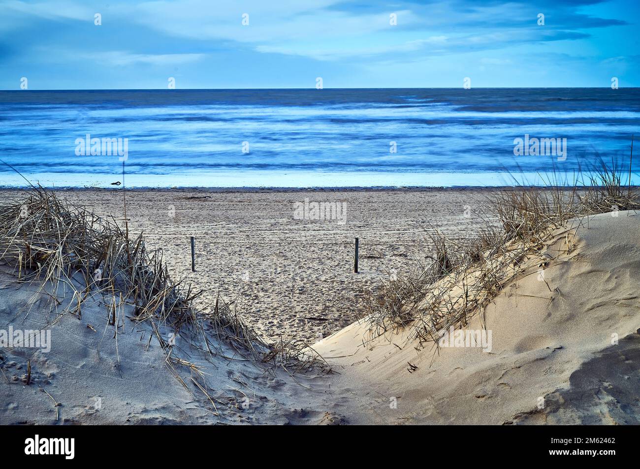 Sand dunes shore and incoming tide Stock Photo - Alamy