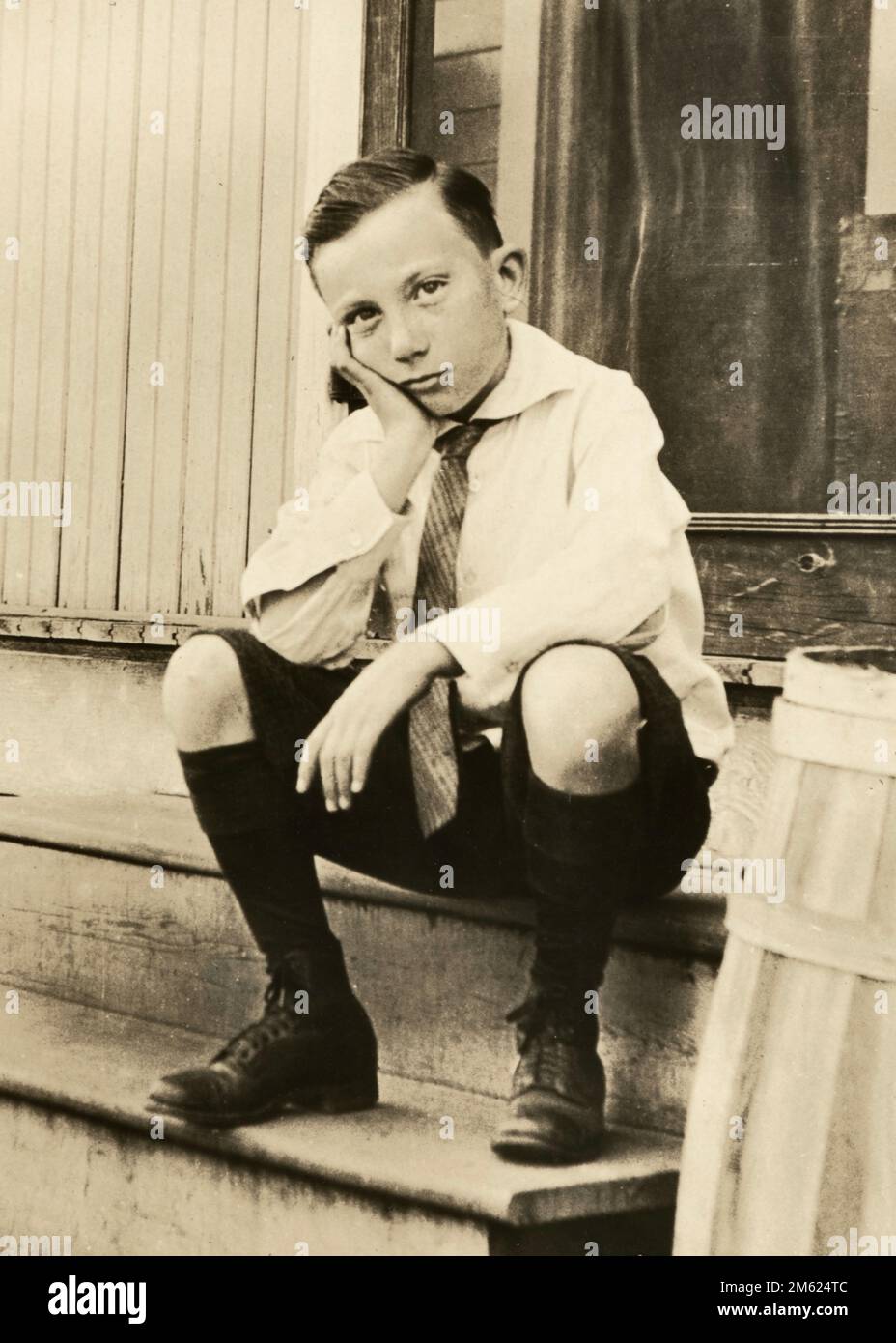 Bored Child, Boy sitting on Steps early 1900s Stock Photo - Alamy