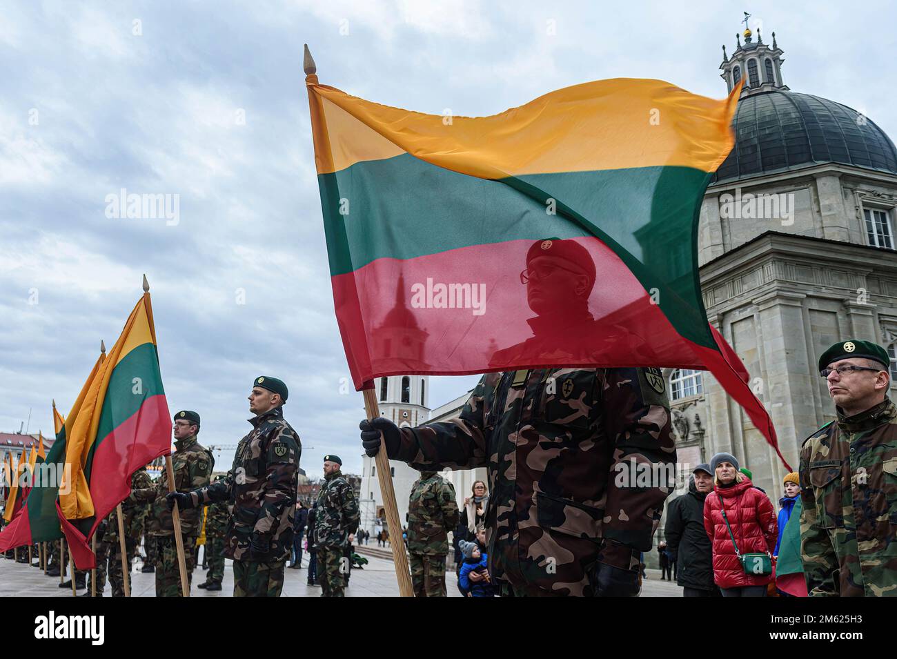 Lithuanian servicemen stand in the guard of honor while holding ...