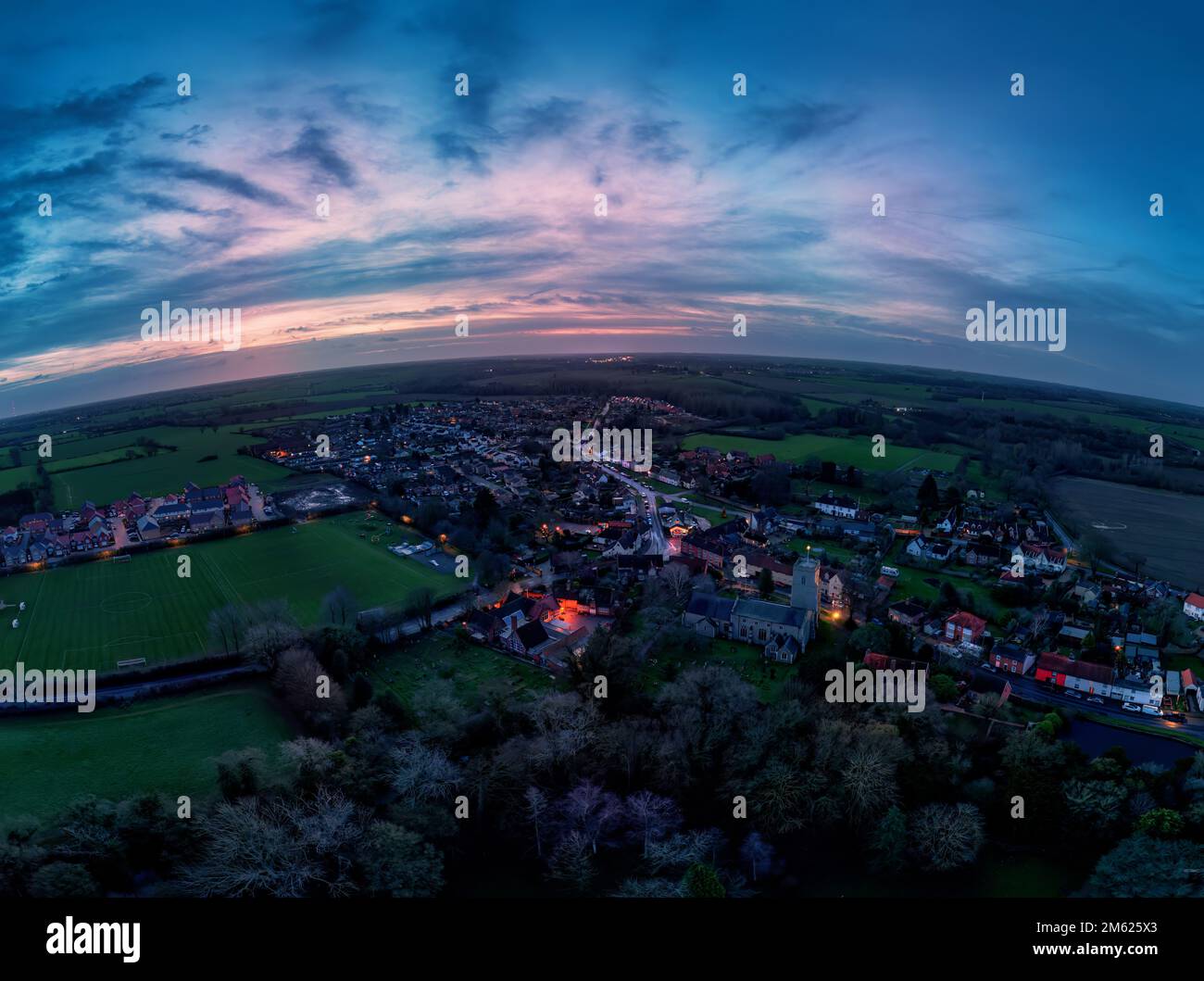 An aerial view at sunrise of the village of Haughley in Suffolk, UK ...